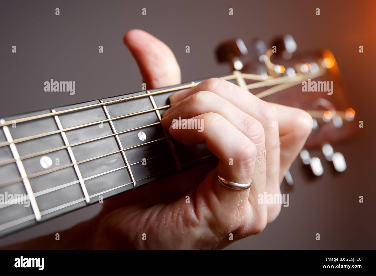 Fingers on the guitar fretboard Stock Photo - Alamy