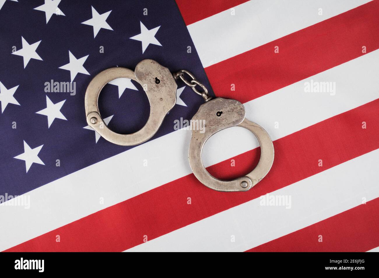 police handcuffs on the usa flag, close-up, top view Stock Photo - Alamy