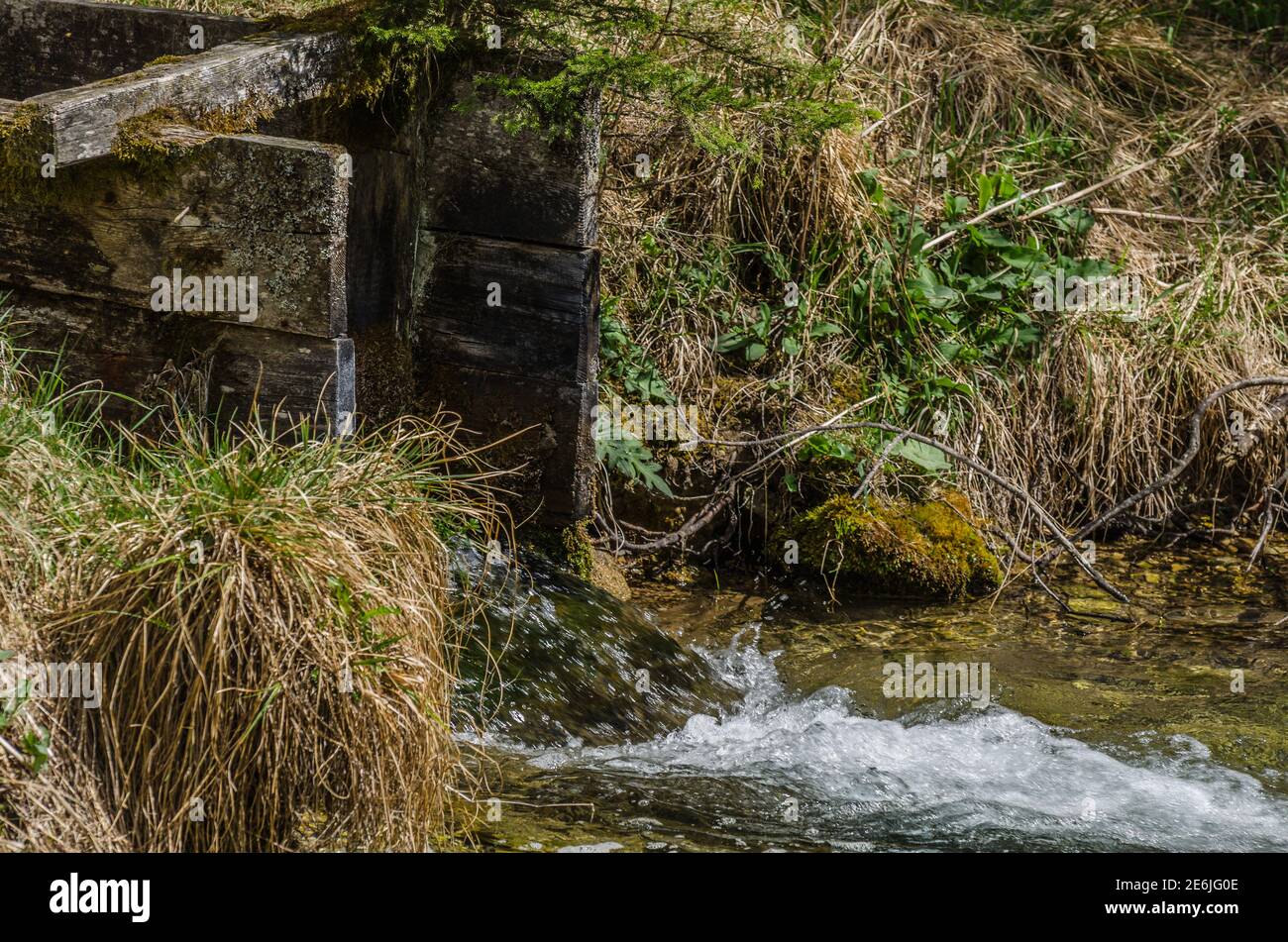 sluice with flowing water at lake Stock Photo - Alamy