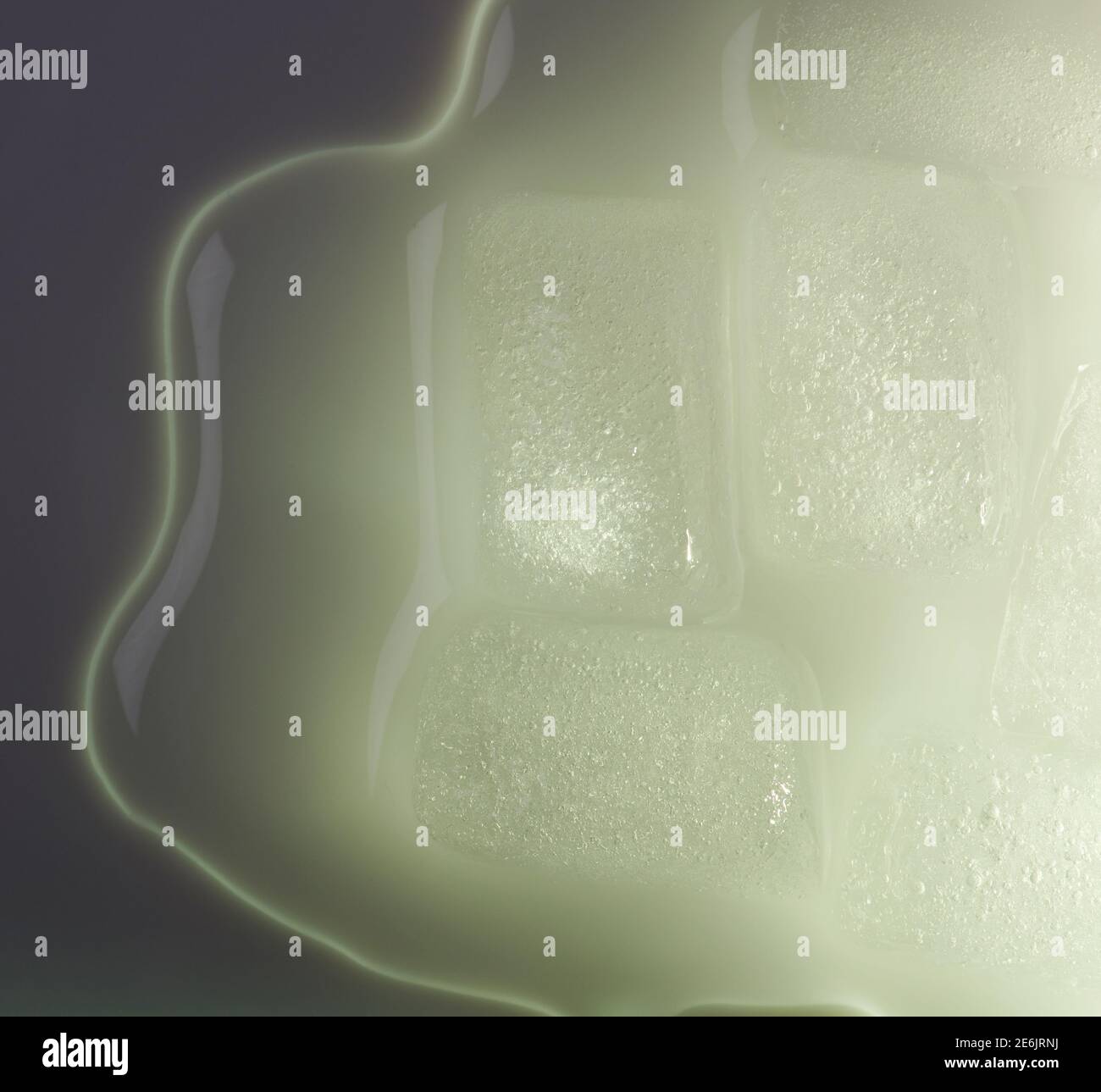 Yellow glowing melt clean ice cube abstract background Stock Photo - Alamy