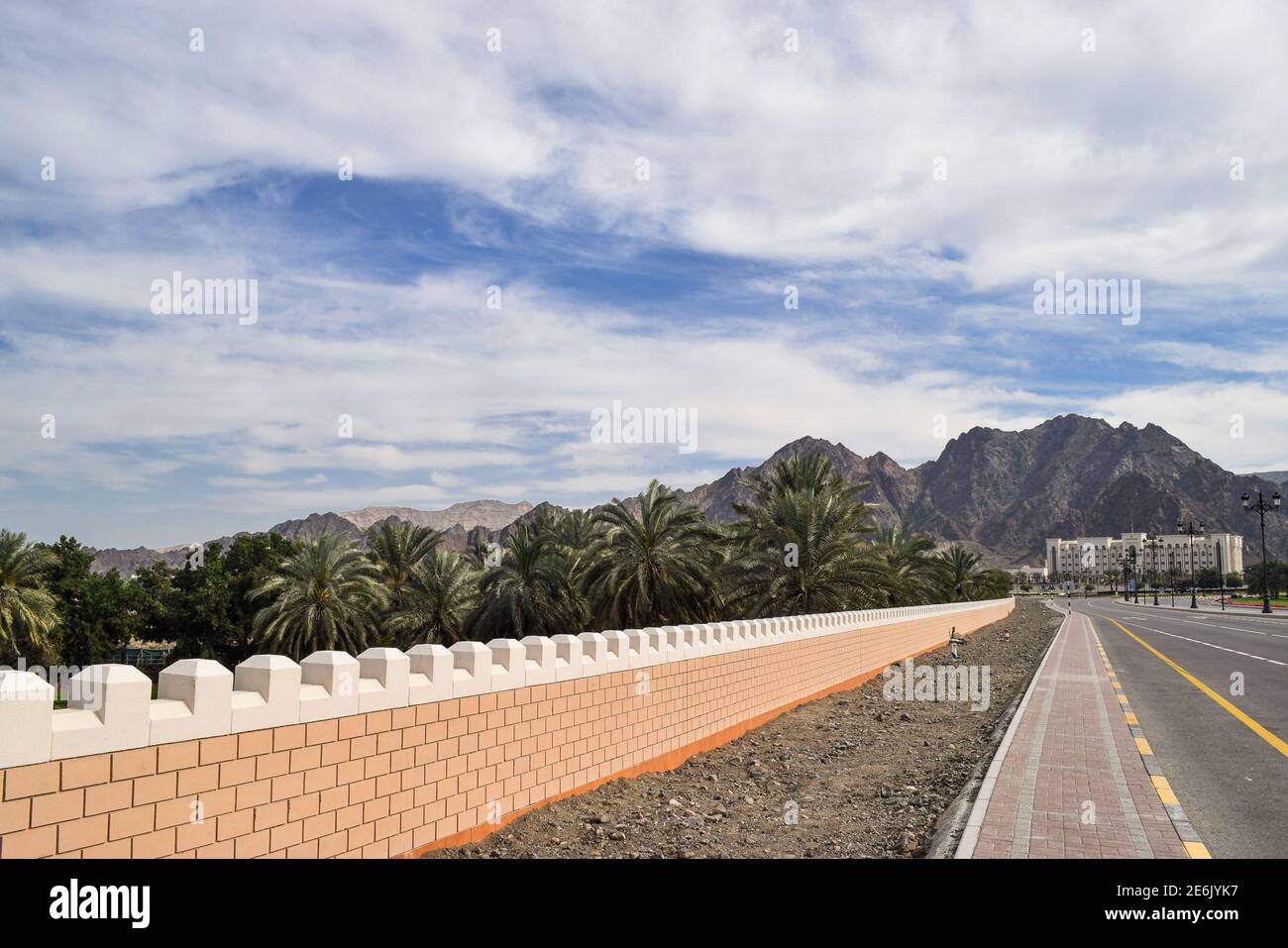 MUSCAT, OMAN - FEBRUARY 9, 2018: A brick wall running along Al Saidiya ...
