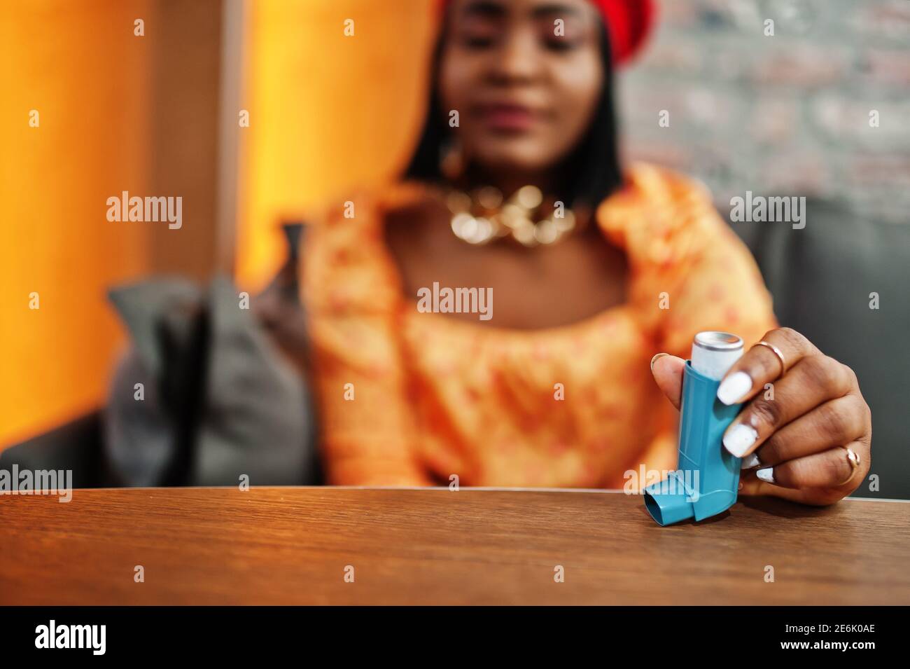 Young african american woman using asthma inhaler. Suffering sickness ...