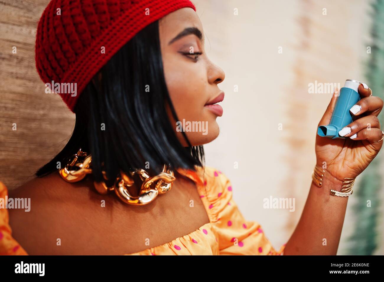 Young african american woman using asthma inhaler. Suffering sickness ...