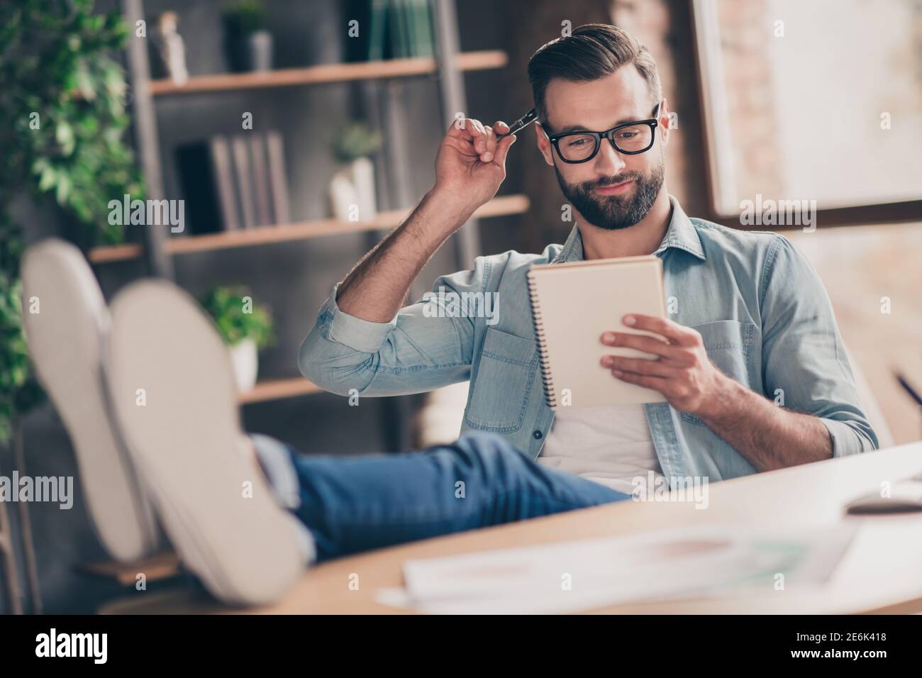 Photo portrait of thinking man reading through notes in notepad with ...