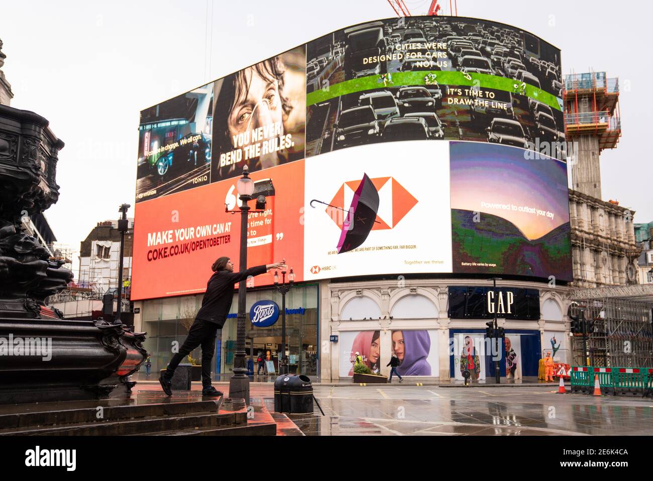 David Field throws an umbrella into the air, as he takes advantage of a ...