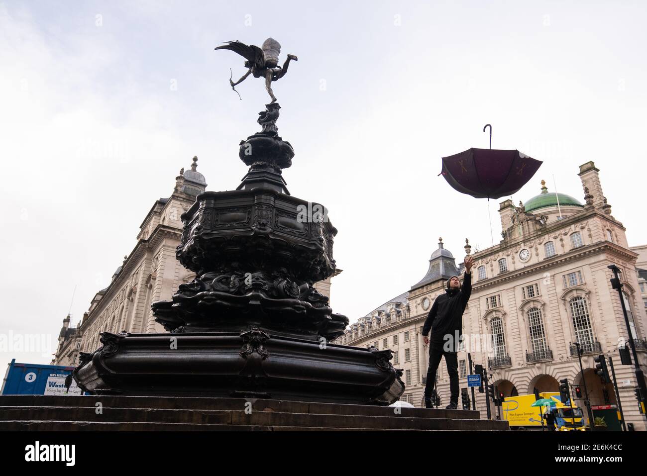 David Field throws an umbrella into the air, as he takes advantage of a ...