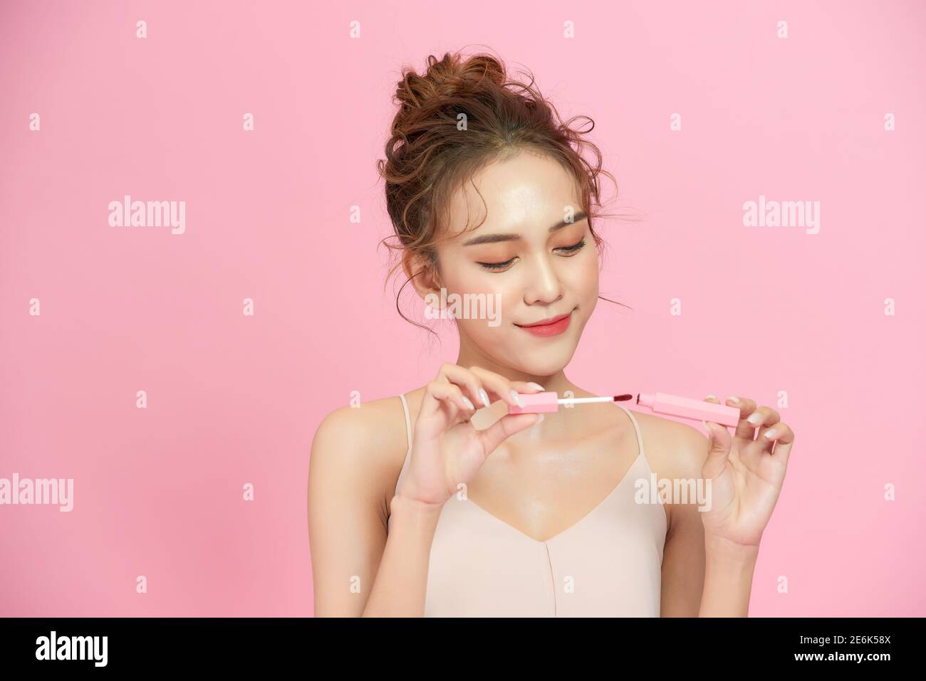 Attractive and beautiful Asian girl paint lips a pink lipstick Stock ...