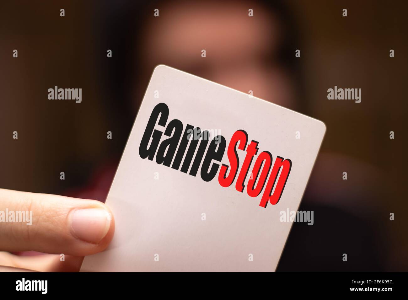 Cambridge UK January 2021 Hand holding a card with the gamestop company ...