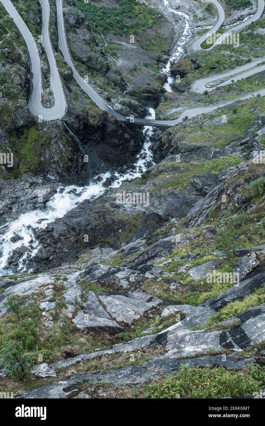 Hairpin bends of Trollstigen mountain pass with Stigfossen waterfall ...