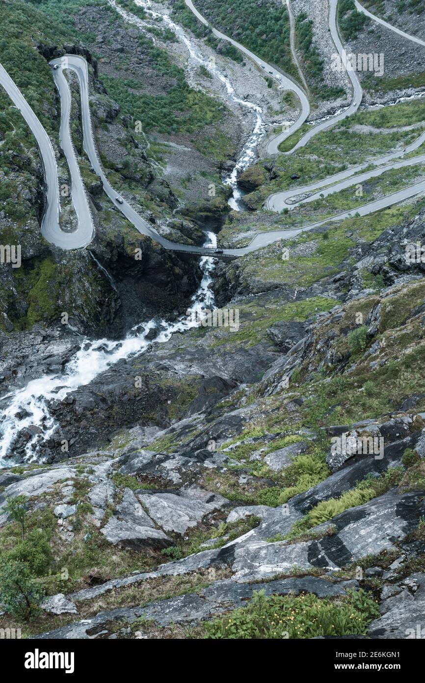 Hairpin bends of Trollstigen mountain pass with Stigfossen waterfall ...