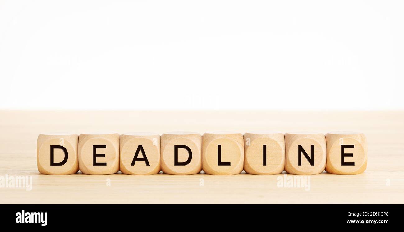 DEADLINE word on wooden blocks on wood table. Copy space. White ...
