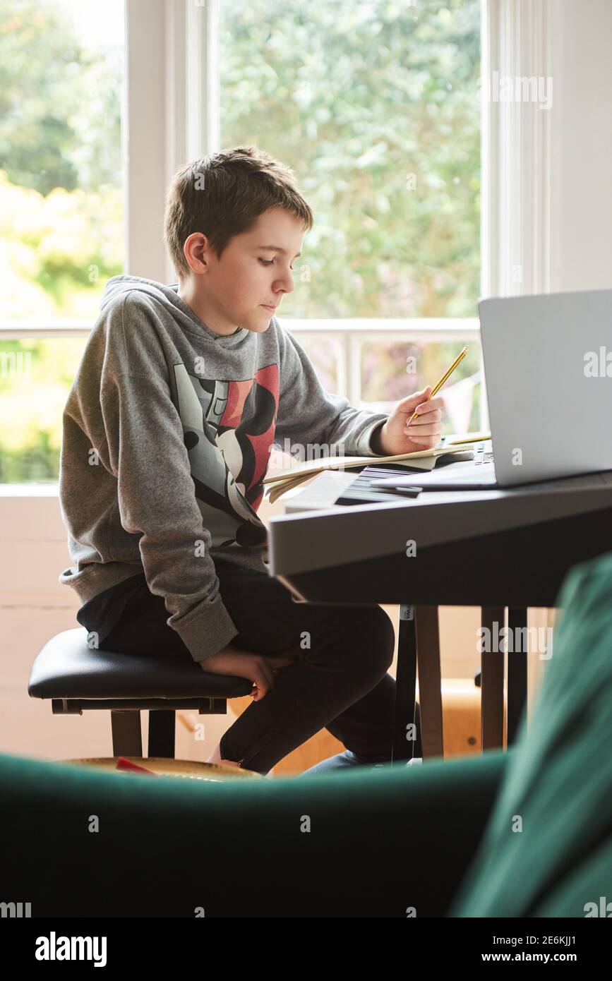 Boy writing notes hi-res stock photography and images - Alamy