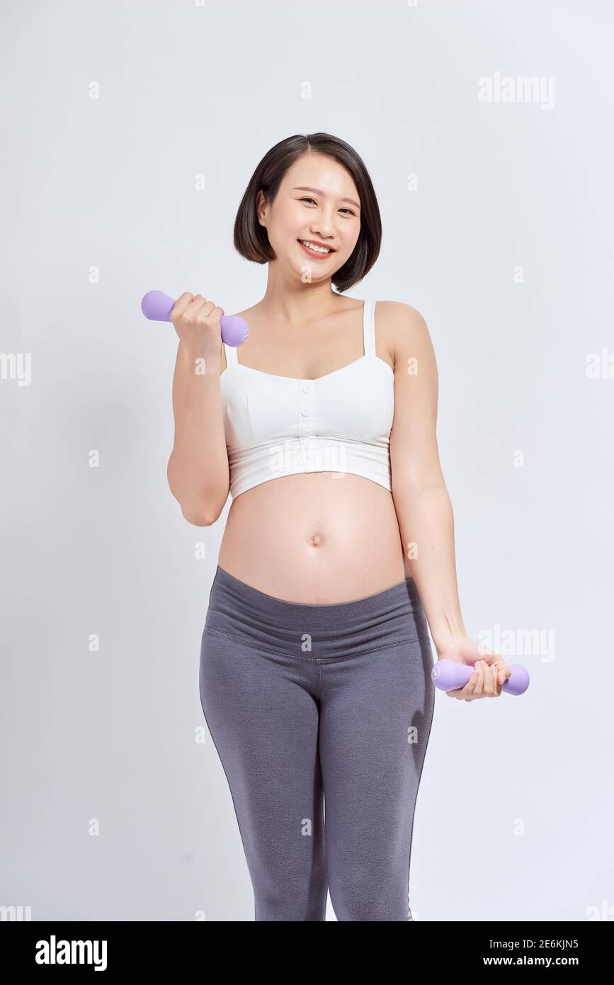 Asian Pregnant Woman Do Exercise Standing And Lifting Dumbbells