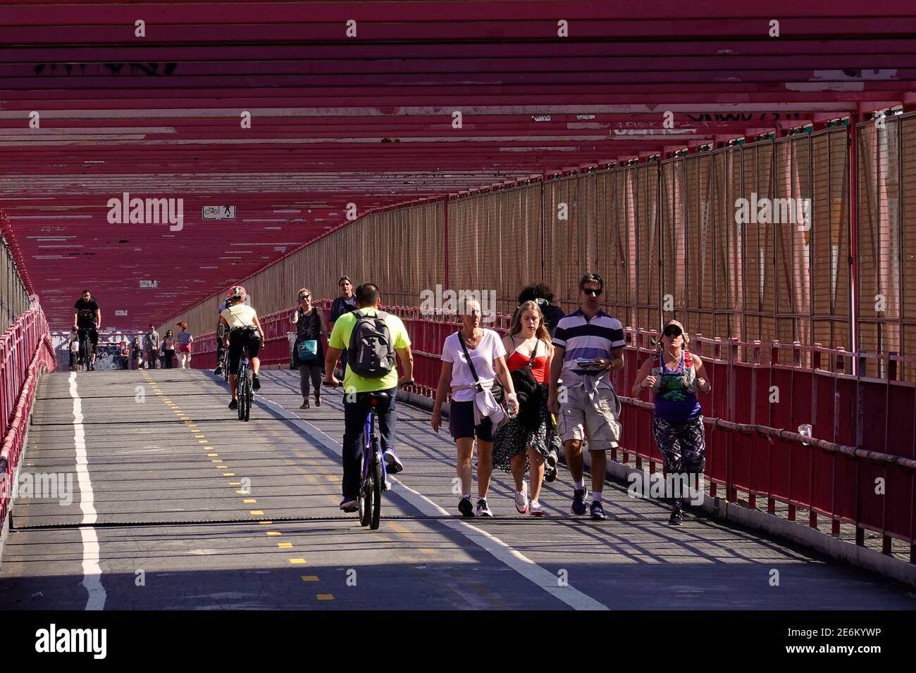 people walking and riding bikes on the Manhattan Bridge NYC Stock Photo ...