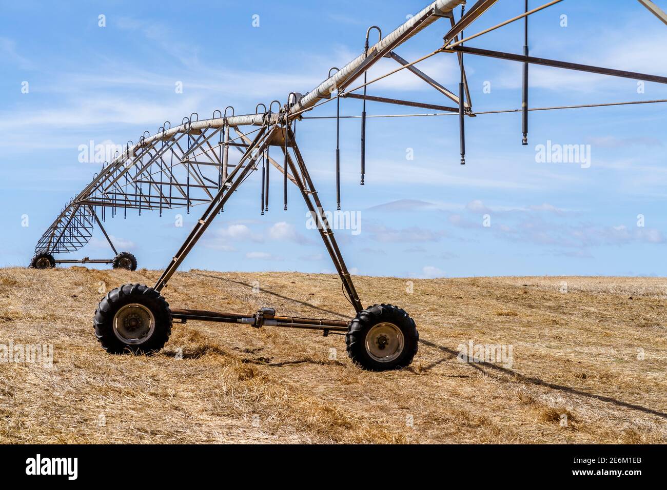Moving irrigation system standing on a dry stubble field in Alentejo ...