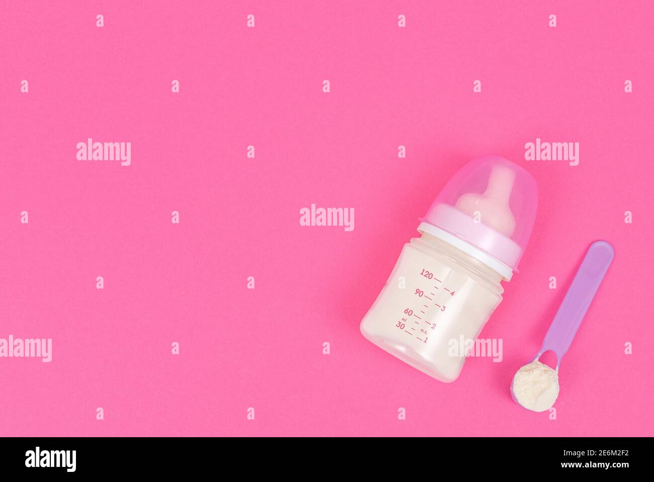 Powder in spoon near baby bottle on white background. Baby food ...
