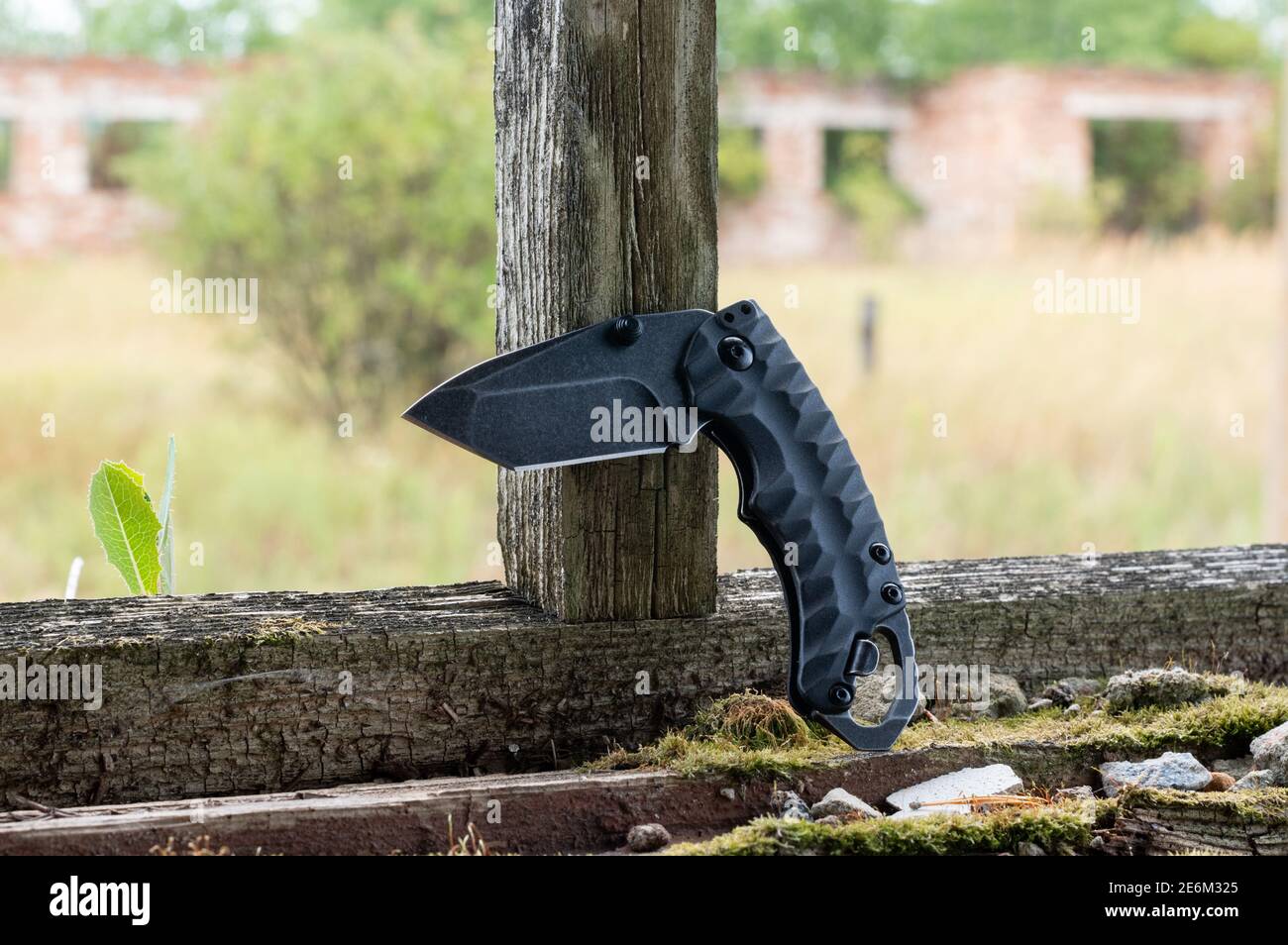 Knife in a semi-folded position in a window frame. The knife is on the ...