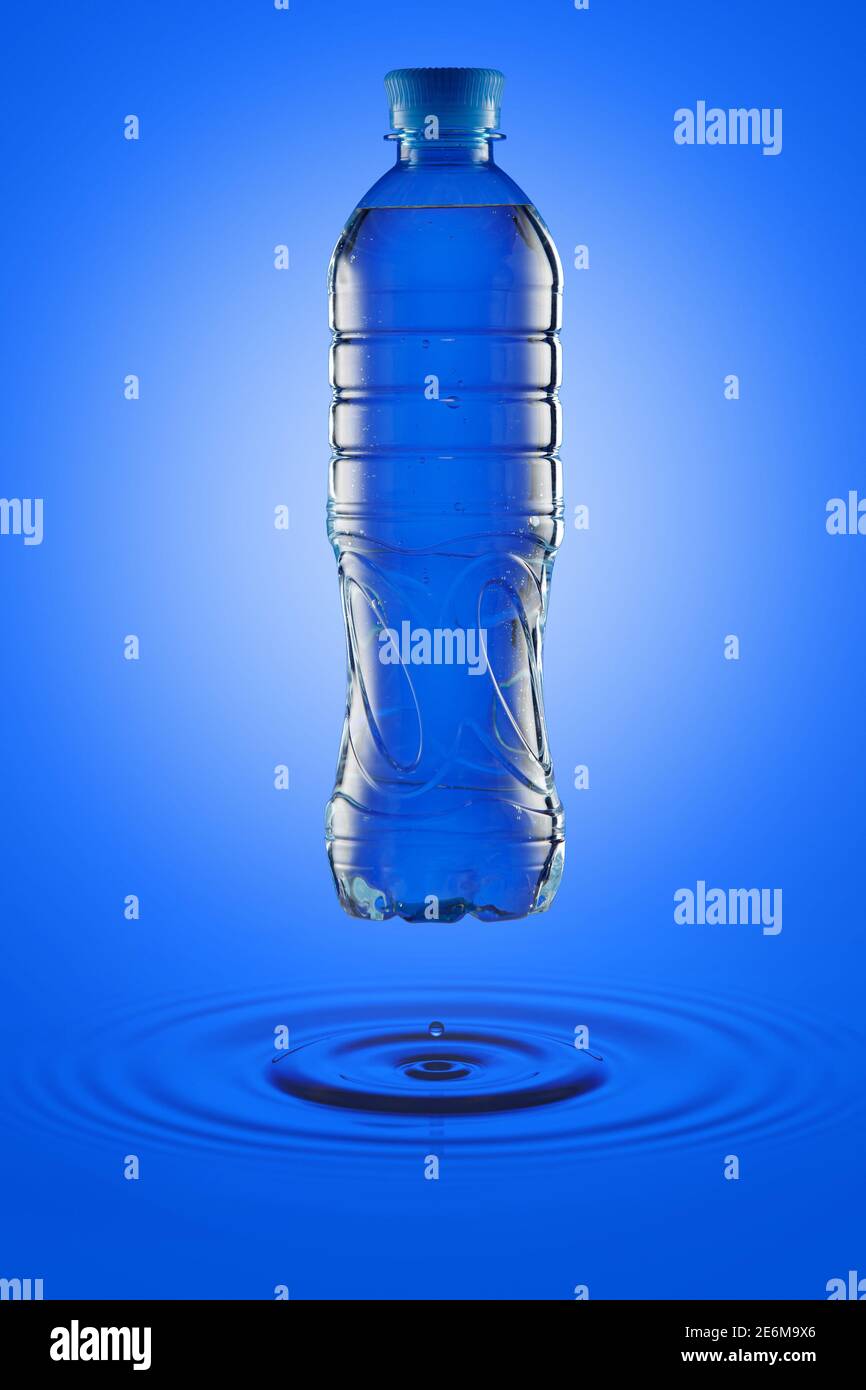 Water in a plastic bottle on a blue background with circular waves ...