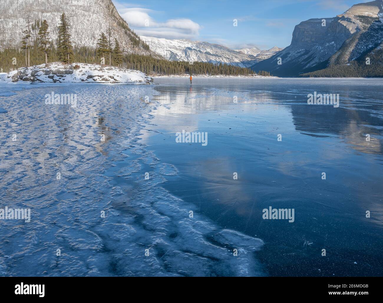 Reflections in frozen Lake Minnewanka in Banff National Park, Alberta ...