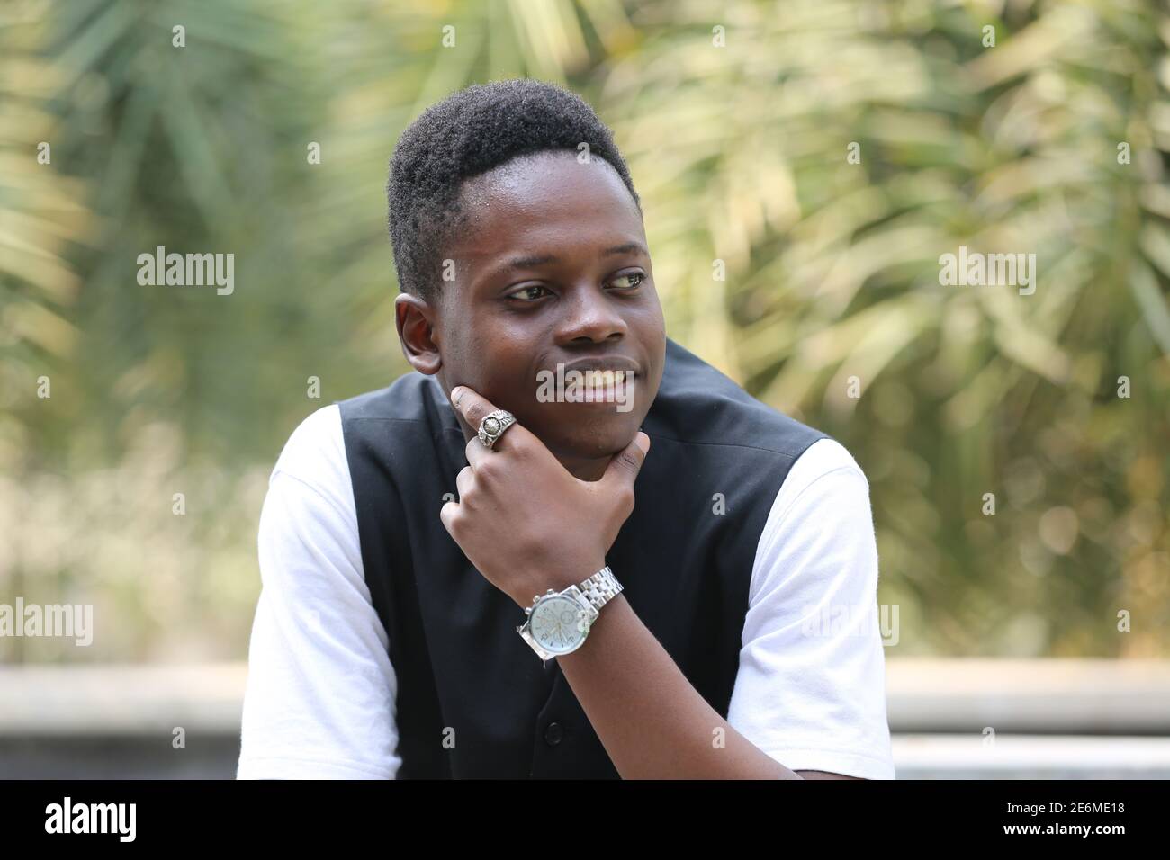 Portrait of young handsome afro black man posing outdoor Stock Photo - Alamy