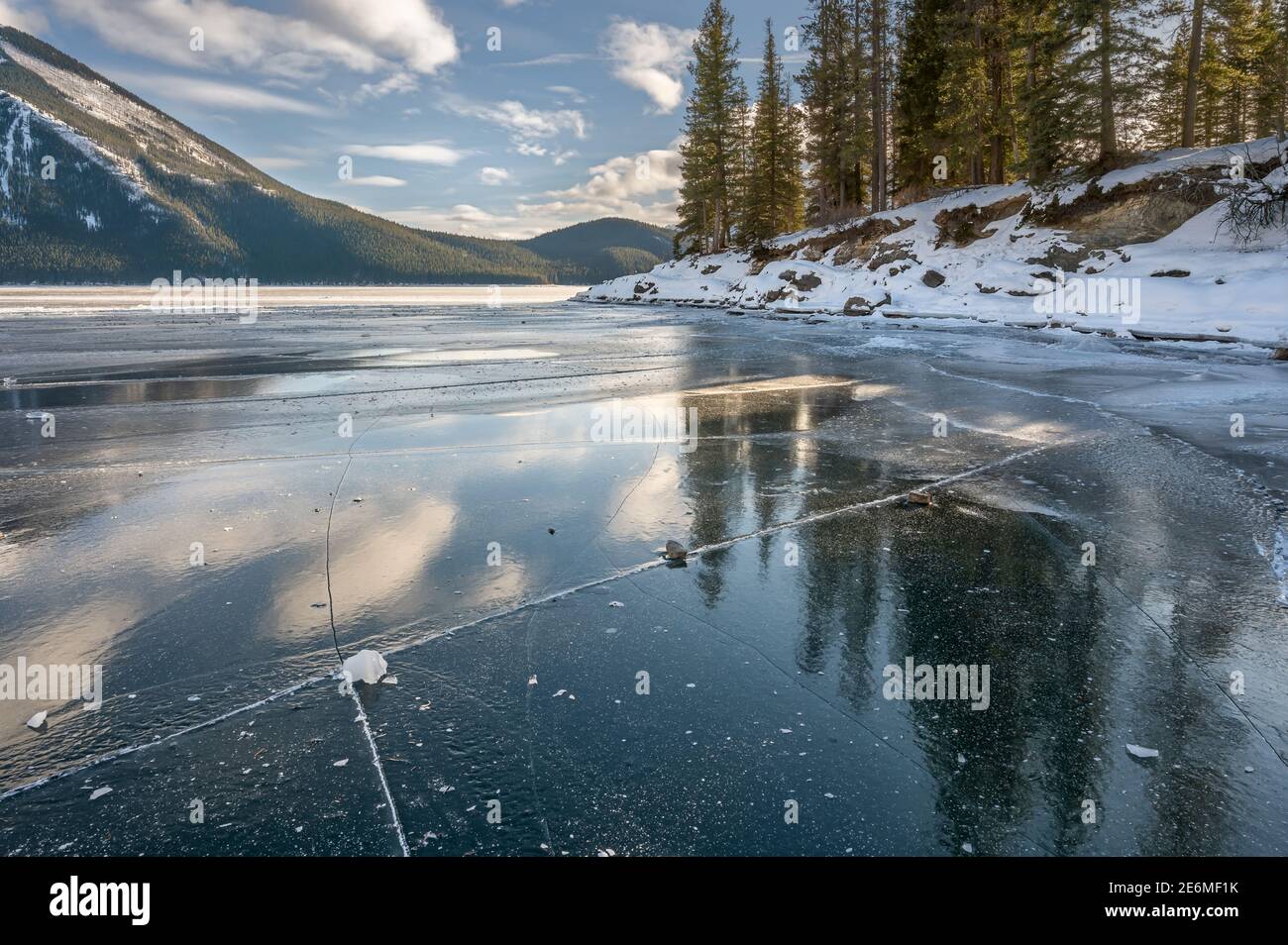 Reflections in frozen Lake Minnewanka in Banff National Park, Alberta ...