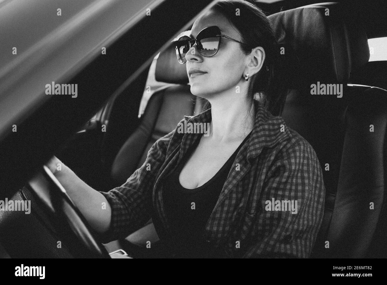 beautiful woman driving and smiling. portrait of happy girl in the car ...