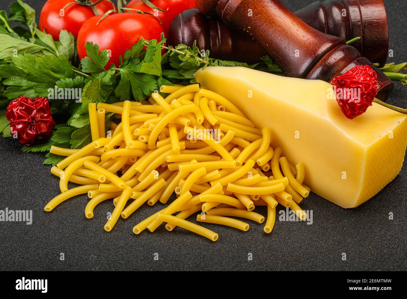 Italian pasta raw Maccheroni for cooking served vegetables Stock Photo ...