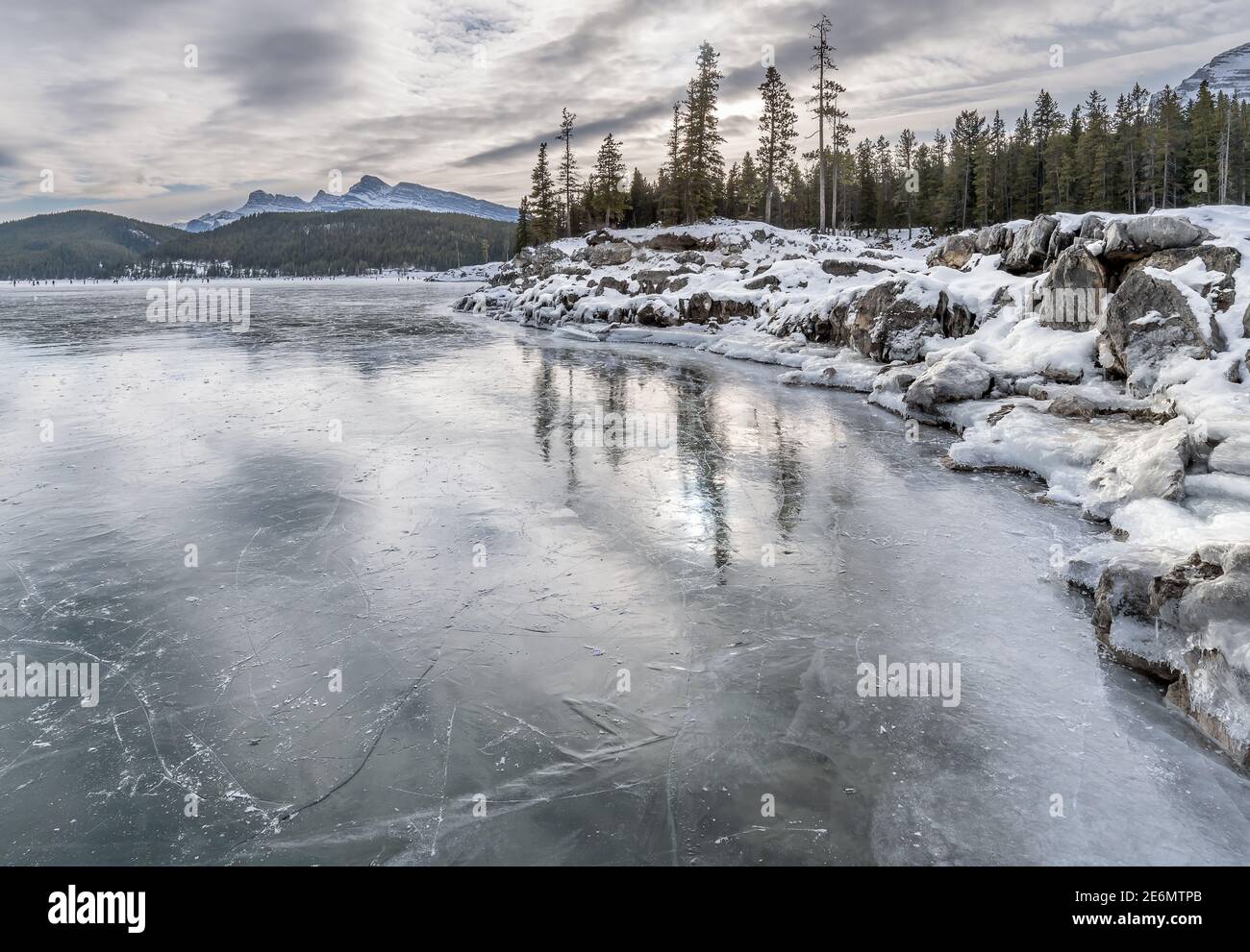Reflections in frozen Lake Minnewanka in Banff National Park, Alberta ...