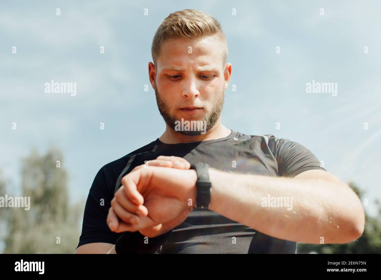 Runner setting time on his sport watch Stock Photo - Alamy