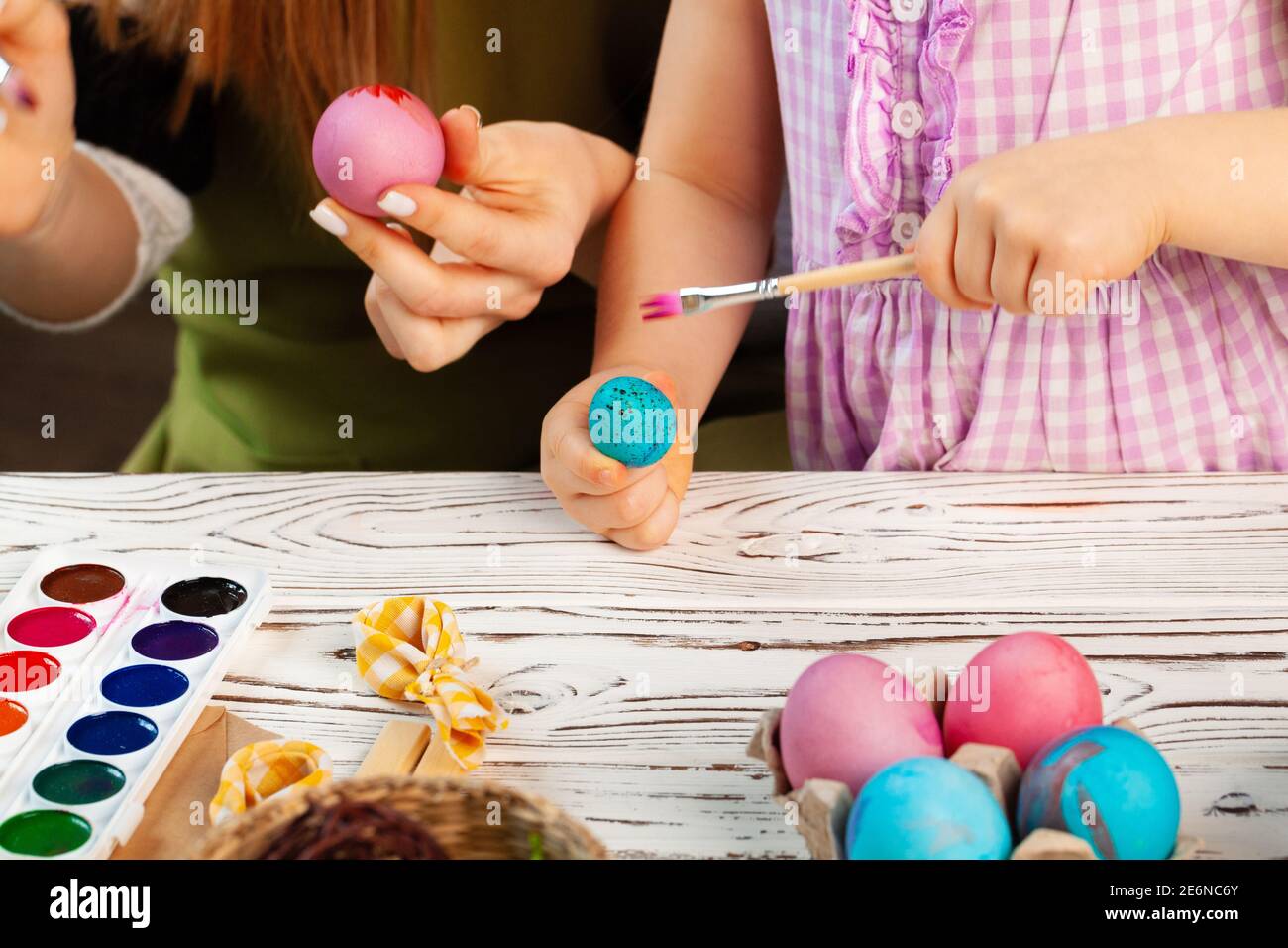 Mother and daughter coloring eggs for Easter Stock Photo - Alamy