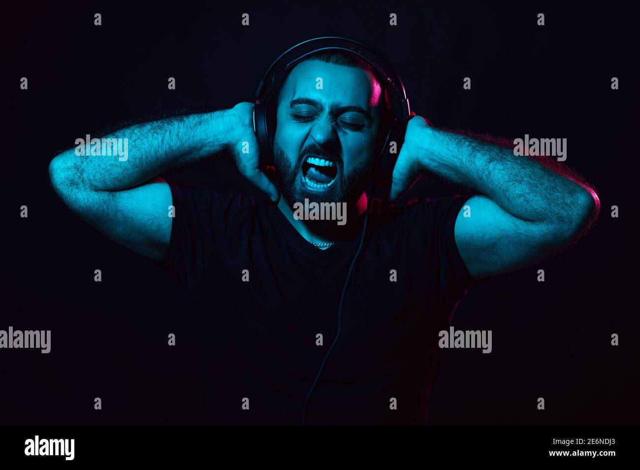 Screaming bearded musician dj with headphones on black isolated ...