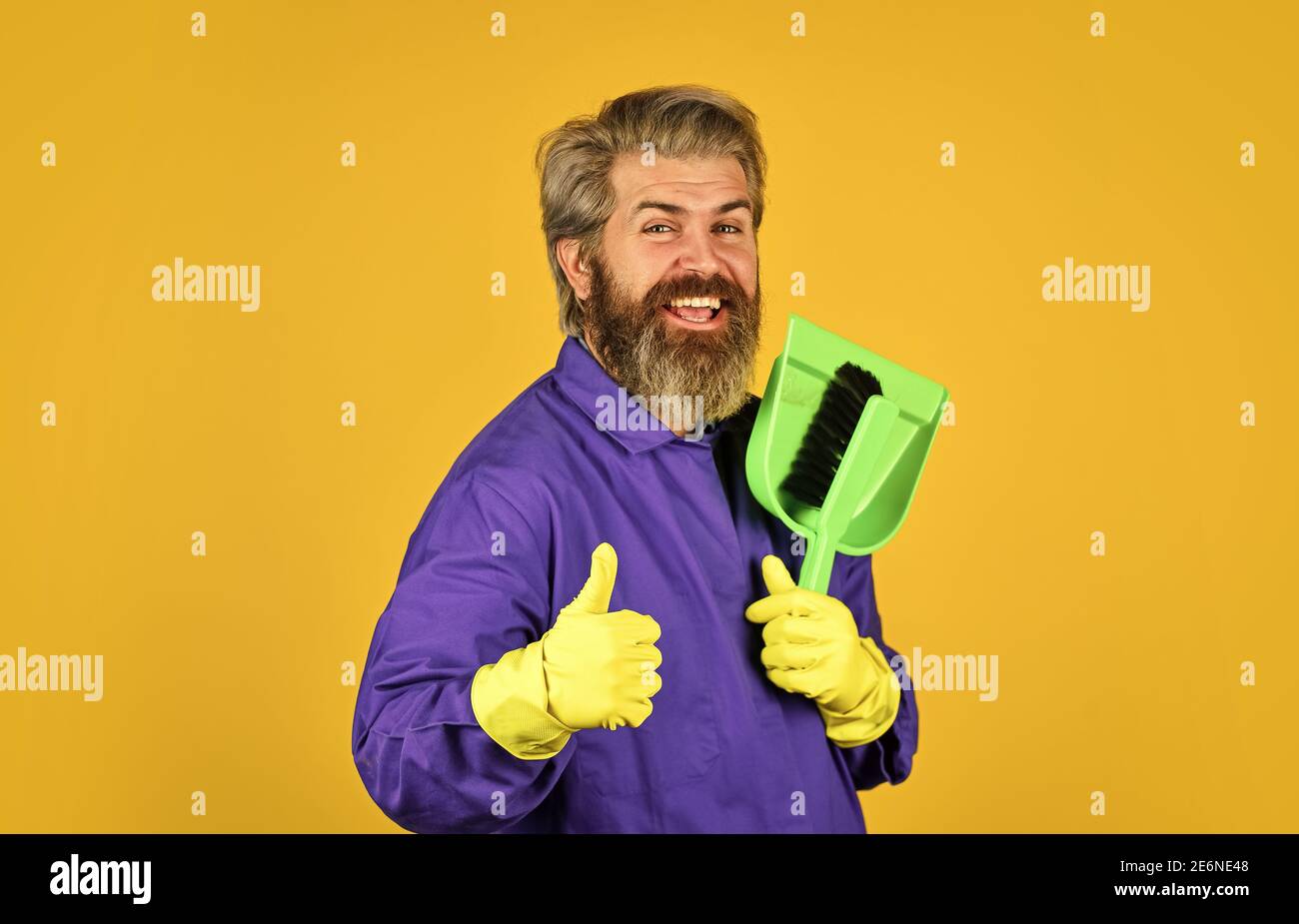 Changing responsibilities. Male janitor with cleaning supply. sweeping ...