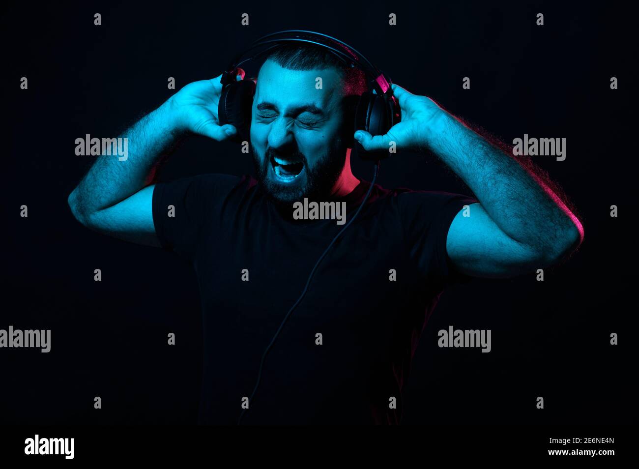 Screaming bearded musician dj with headphones on black isolated ...