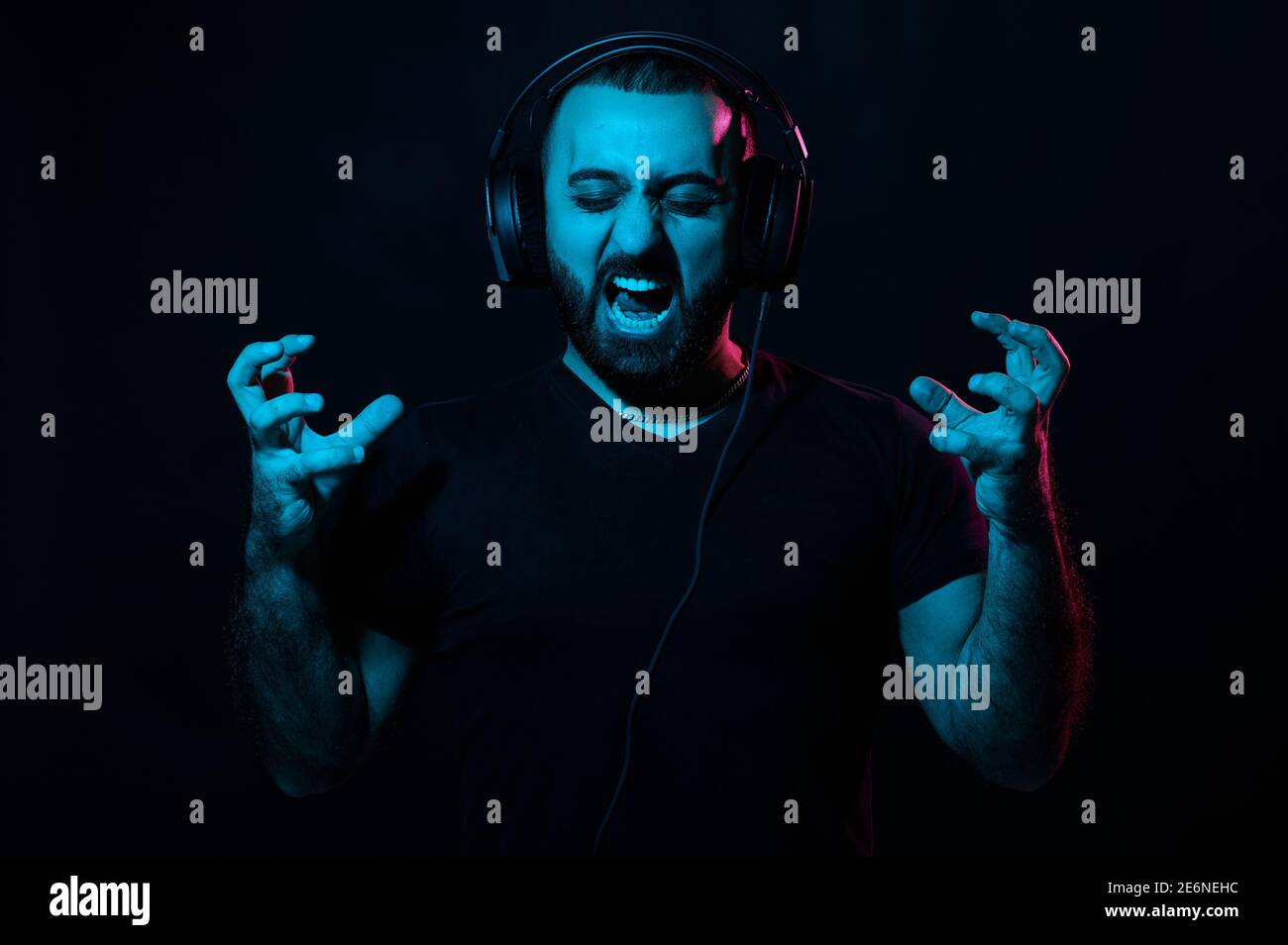 Screaming bearded musician dj with headphones on black isolated ...