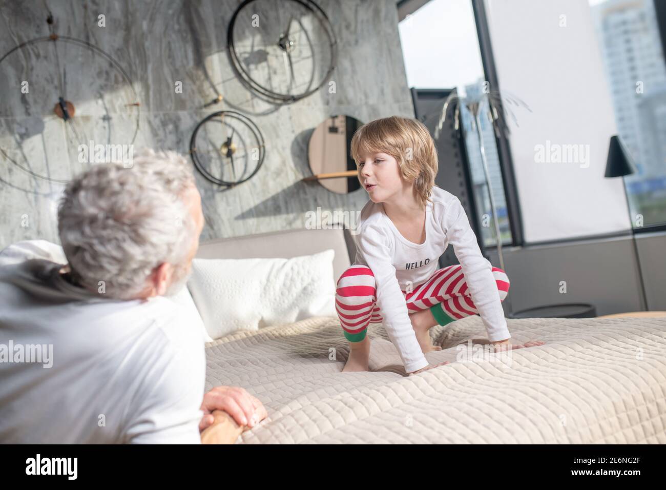 Child copying movement and facial expressions and dad Stock Photo - Alamy