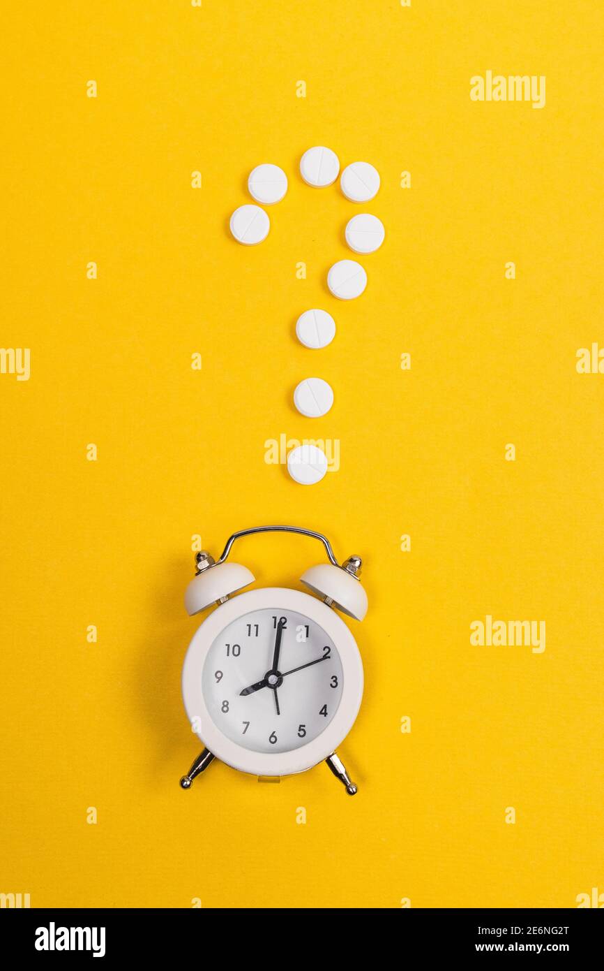 Contraception Day contraceptive pills with alarm clock on yellow ...