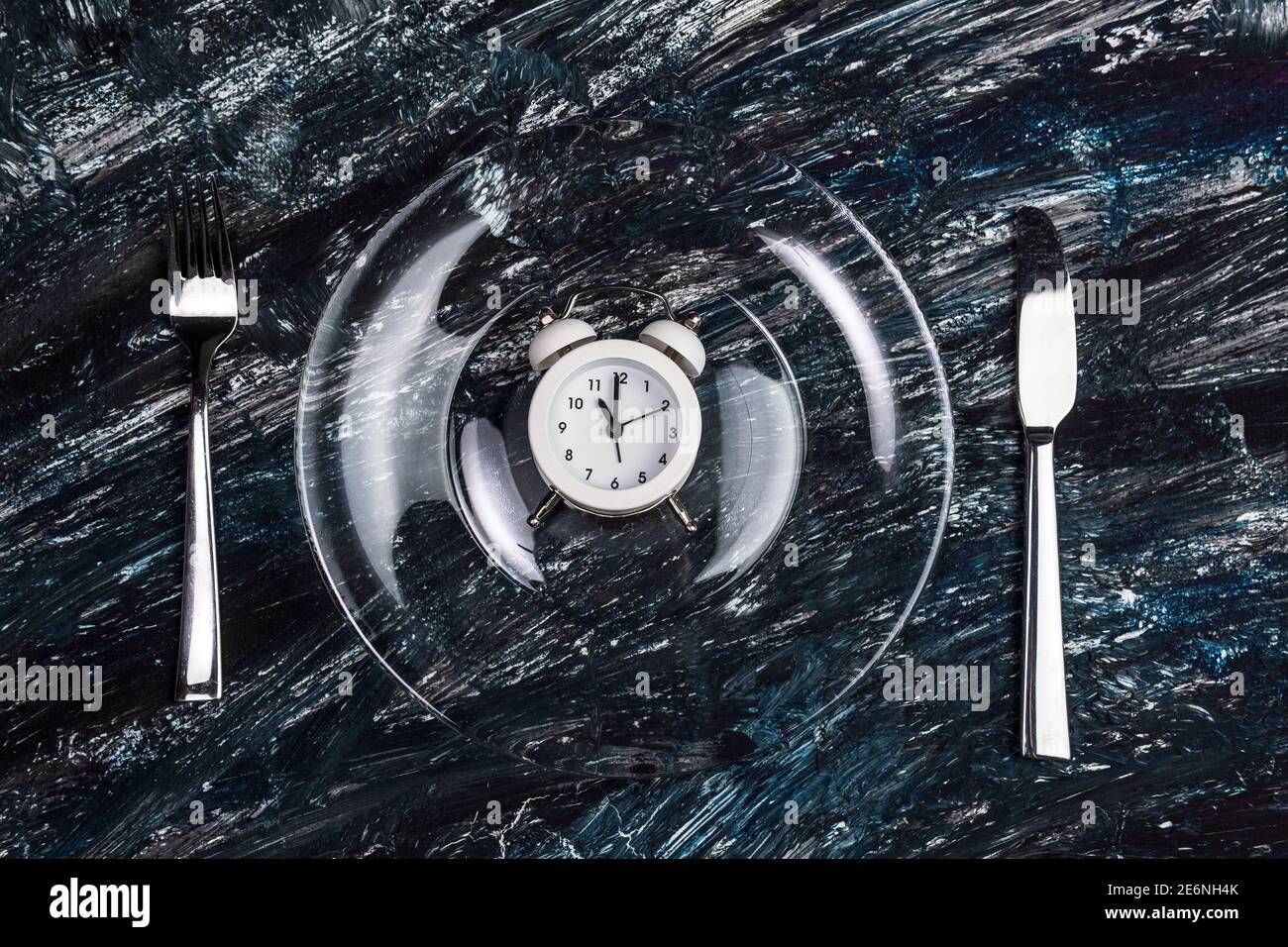 Alarm clock on the plate with fork and knife, lunch time concept, top ...