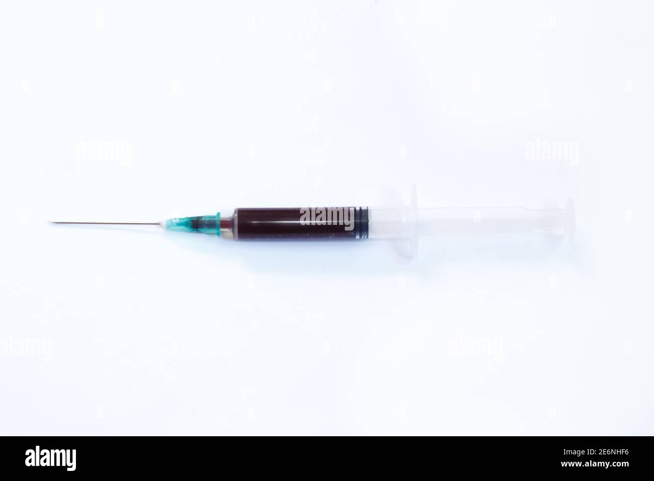 Medical syringe with blood inside isolated on white background with ...