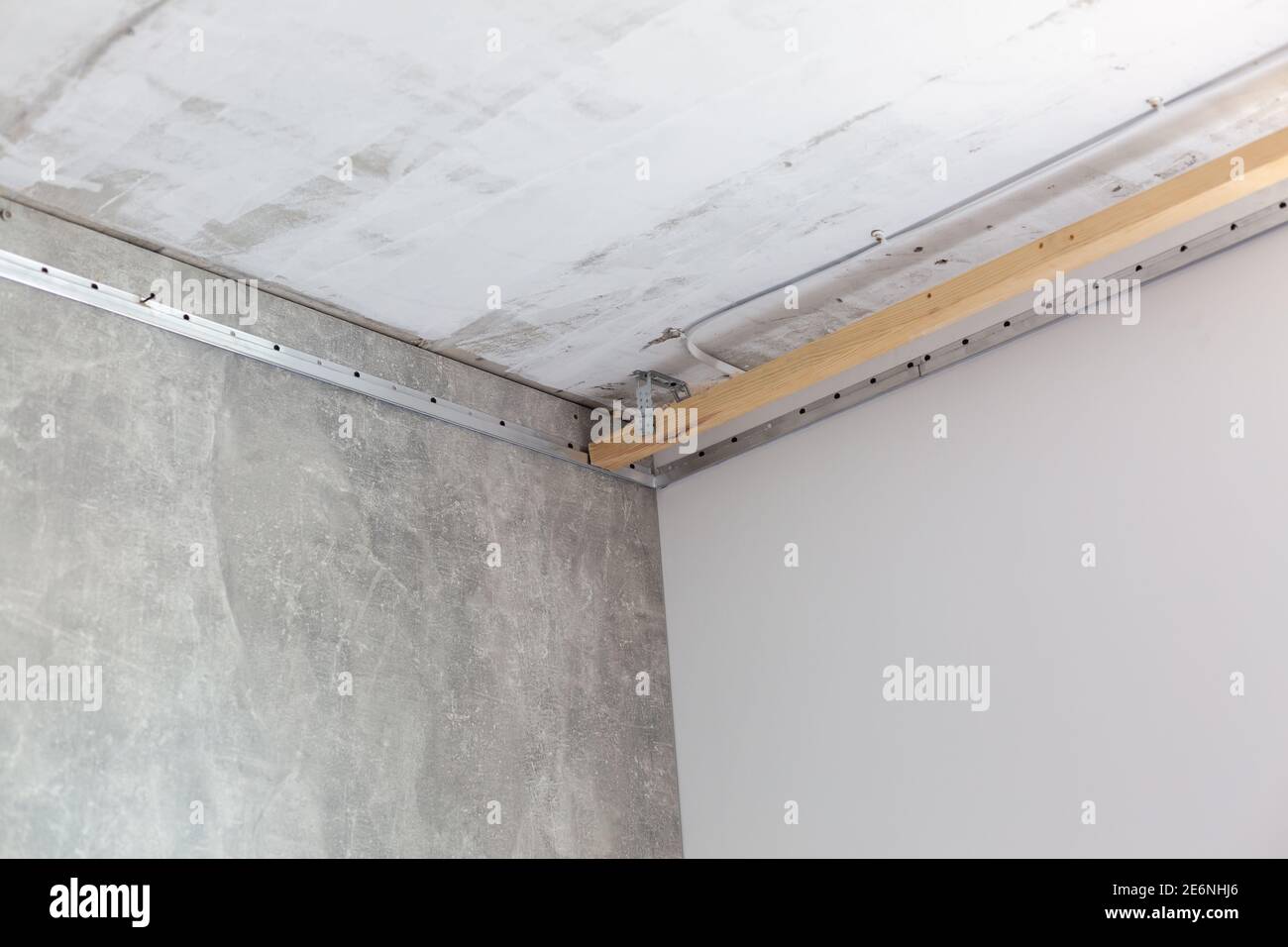 repairmen install stretch ceiling made of pvc vinyl film using a gas ...