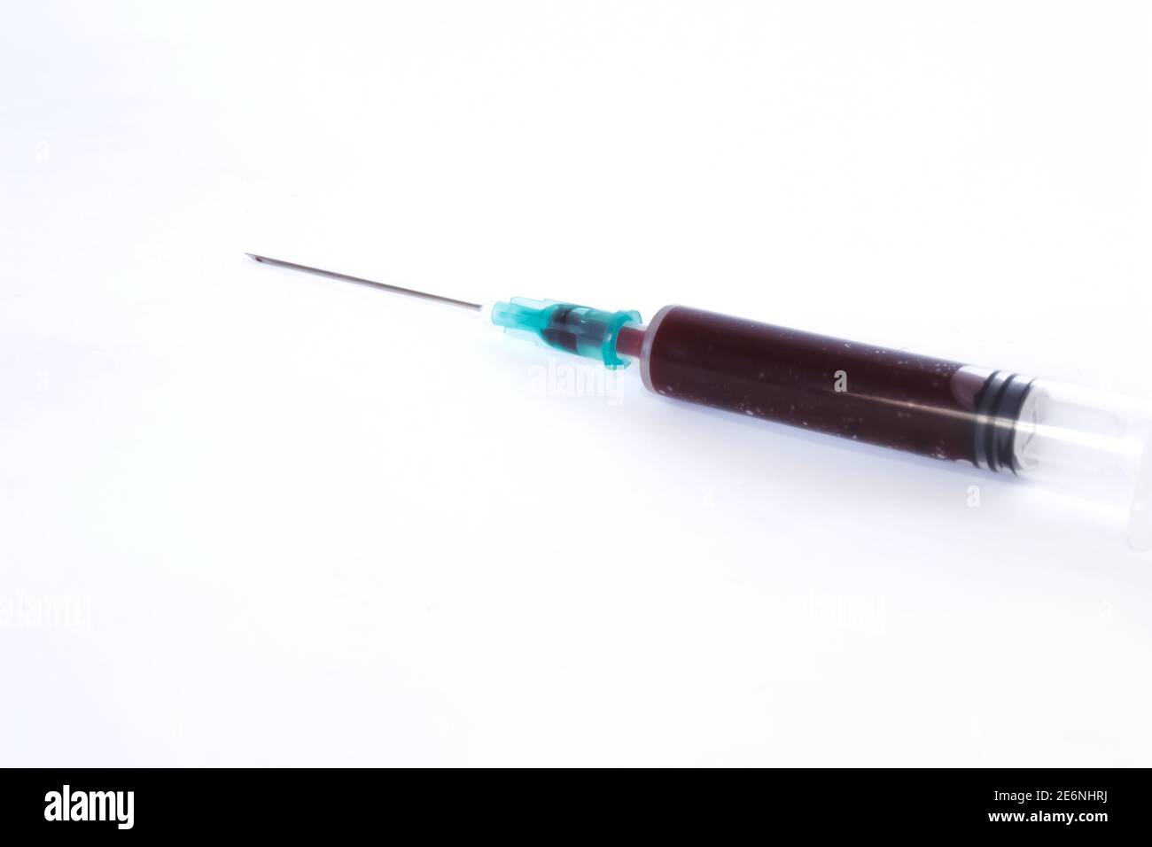 Medical syringe with blood inside isolated on white background with ...