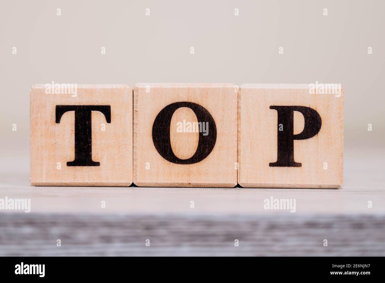 Word TOP on wooden cubes over bright background with copy space ...