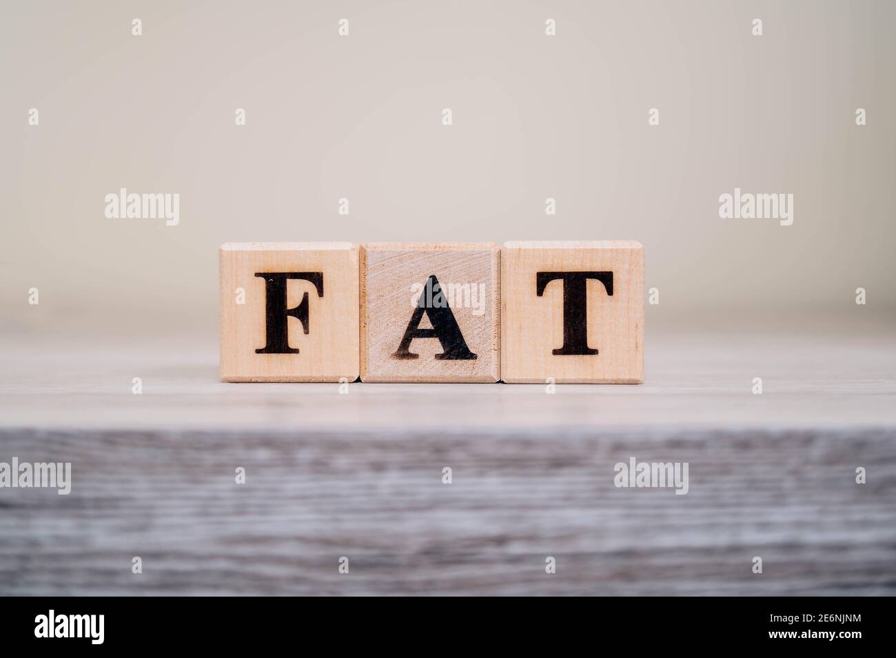 Word FAT on wooden cubes over bright background with copy space Stock ...
