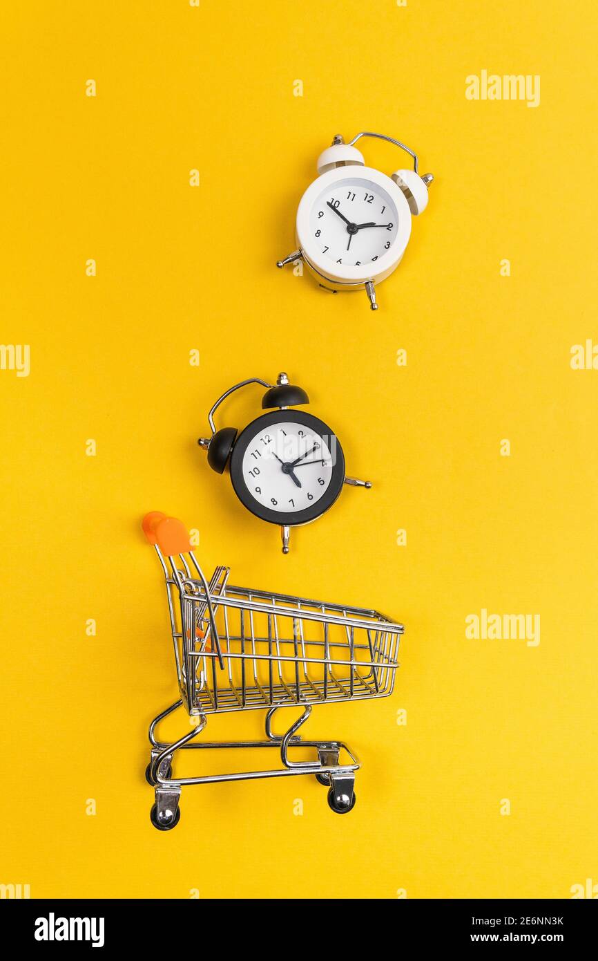 Time to shopping concept, clock on a yellow background. vertical photo ...