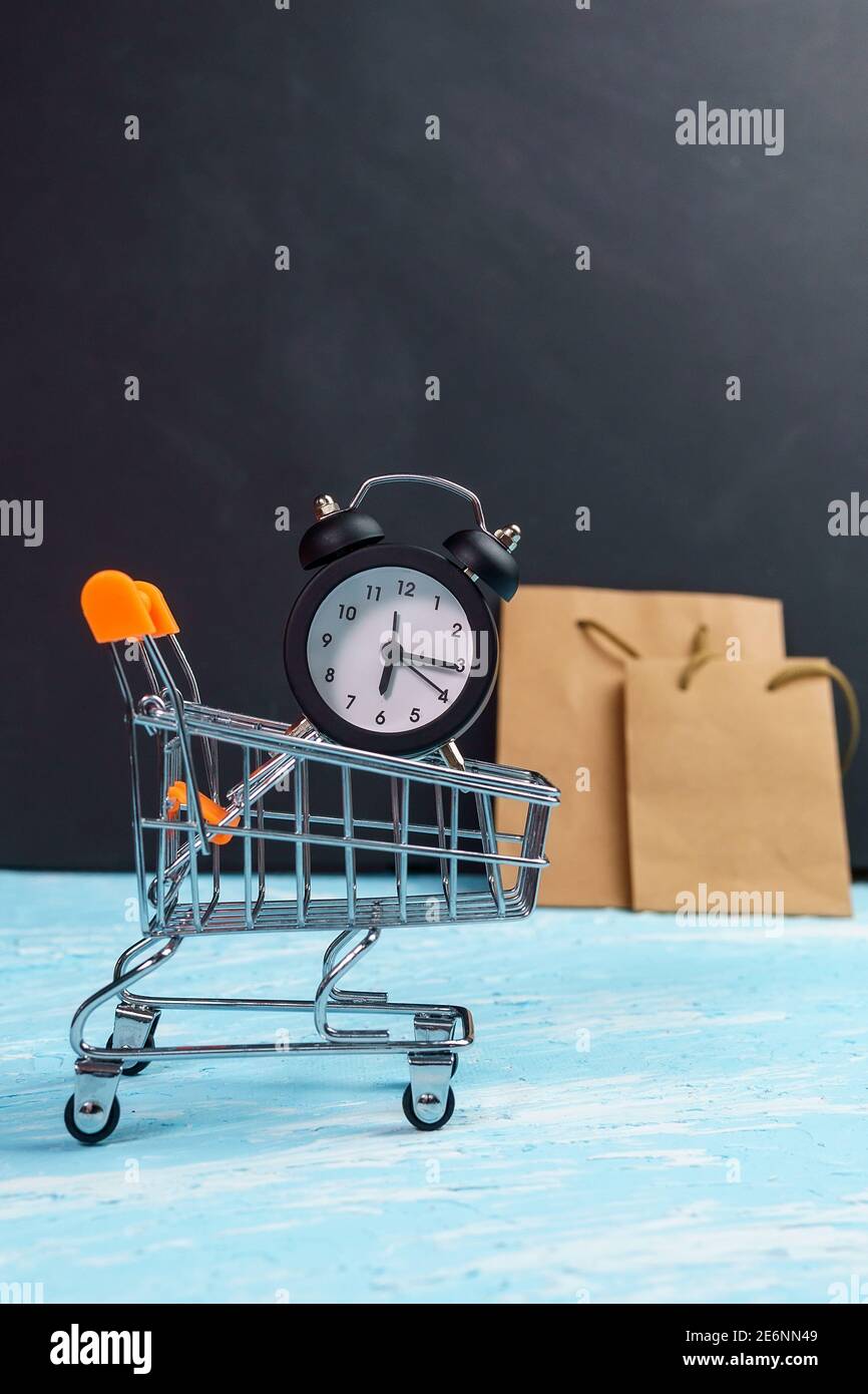 clock on the shopping cart, lack of time, waste of time, purchasing ...