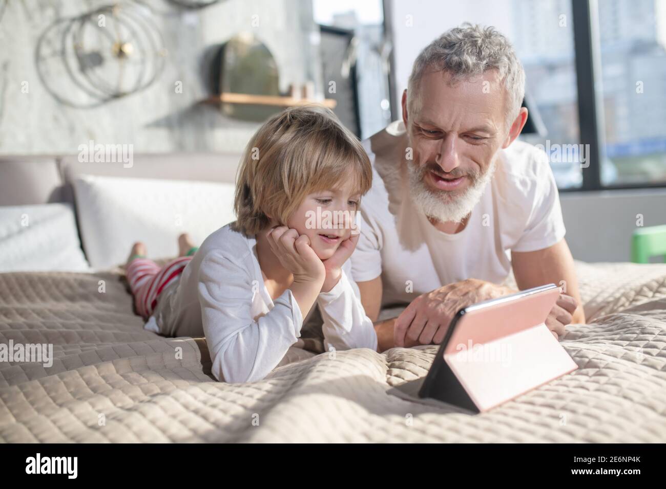 Dad and kid spending time together with tablet Stock Photo - Alamy