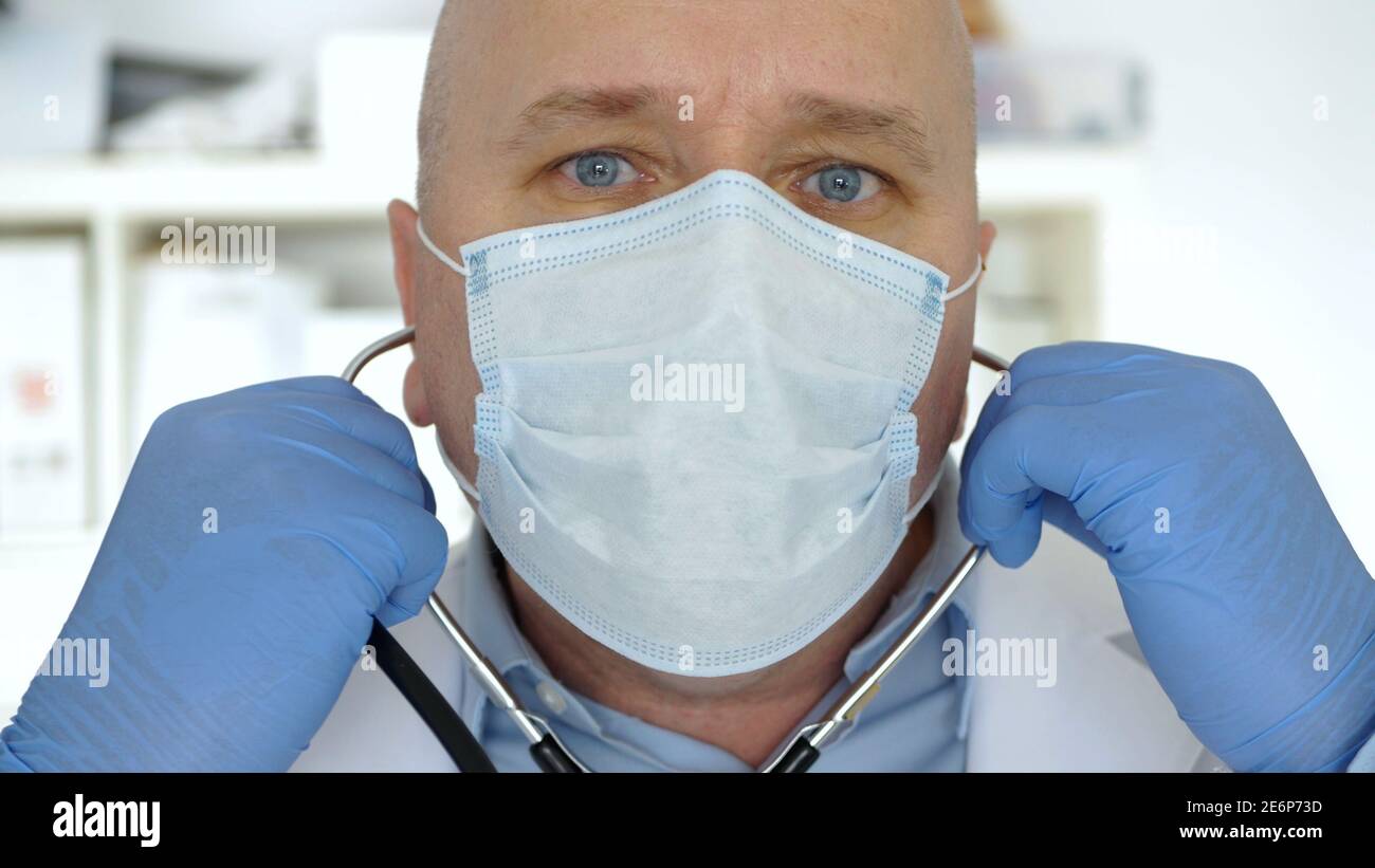 Doctor in a Hospital Wearing Protective Face Mask and Surgical Gloves ...