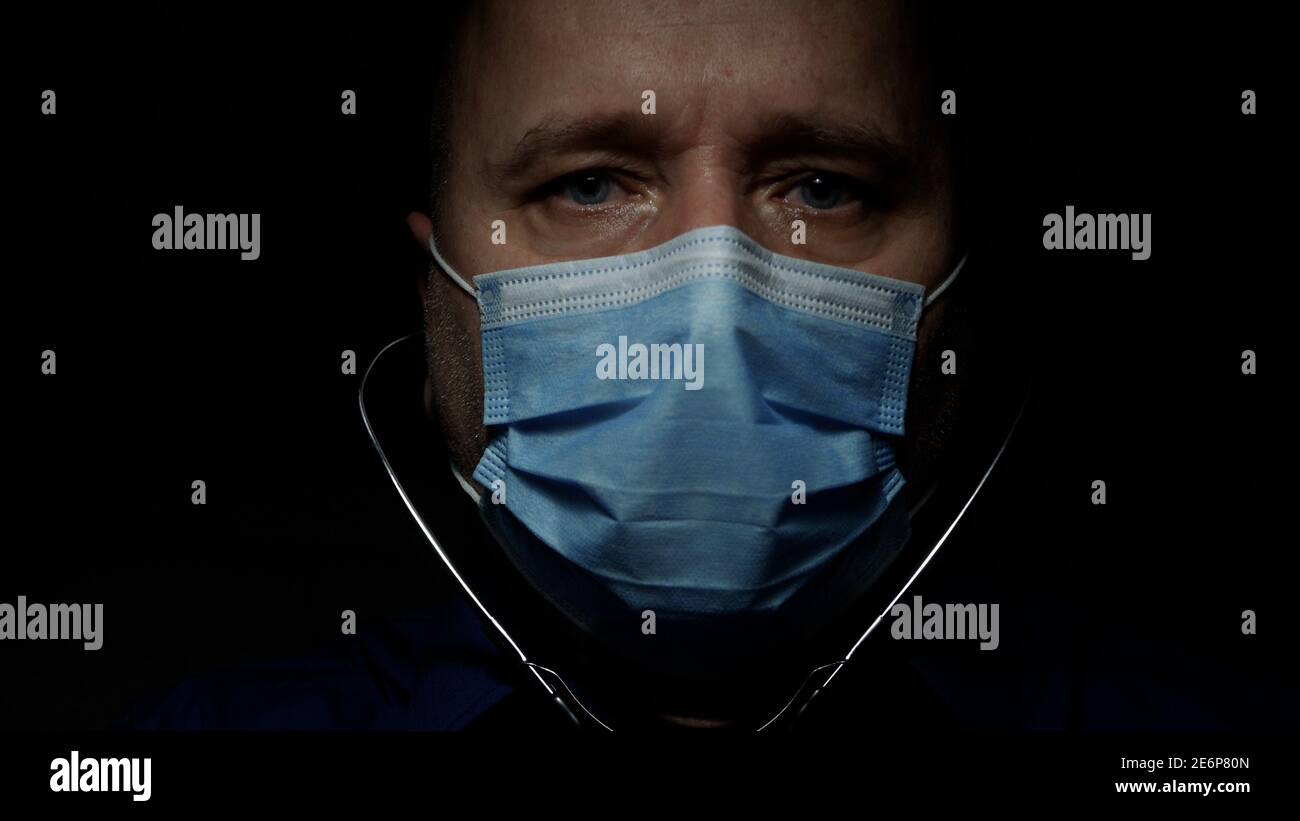 Doctor in a Hospital Wearing Protective Face Mask and Surgical Gloves ...