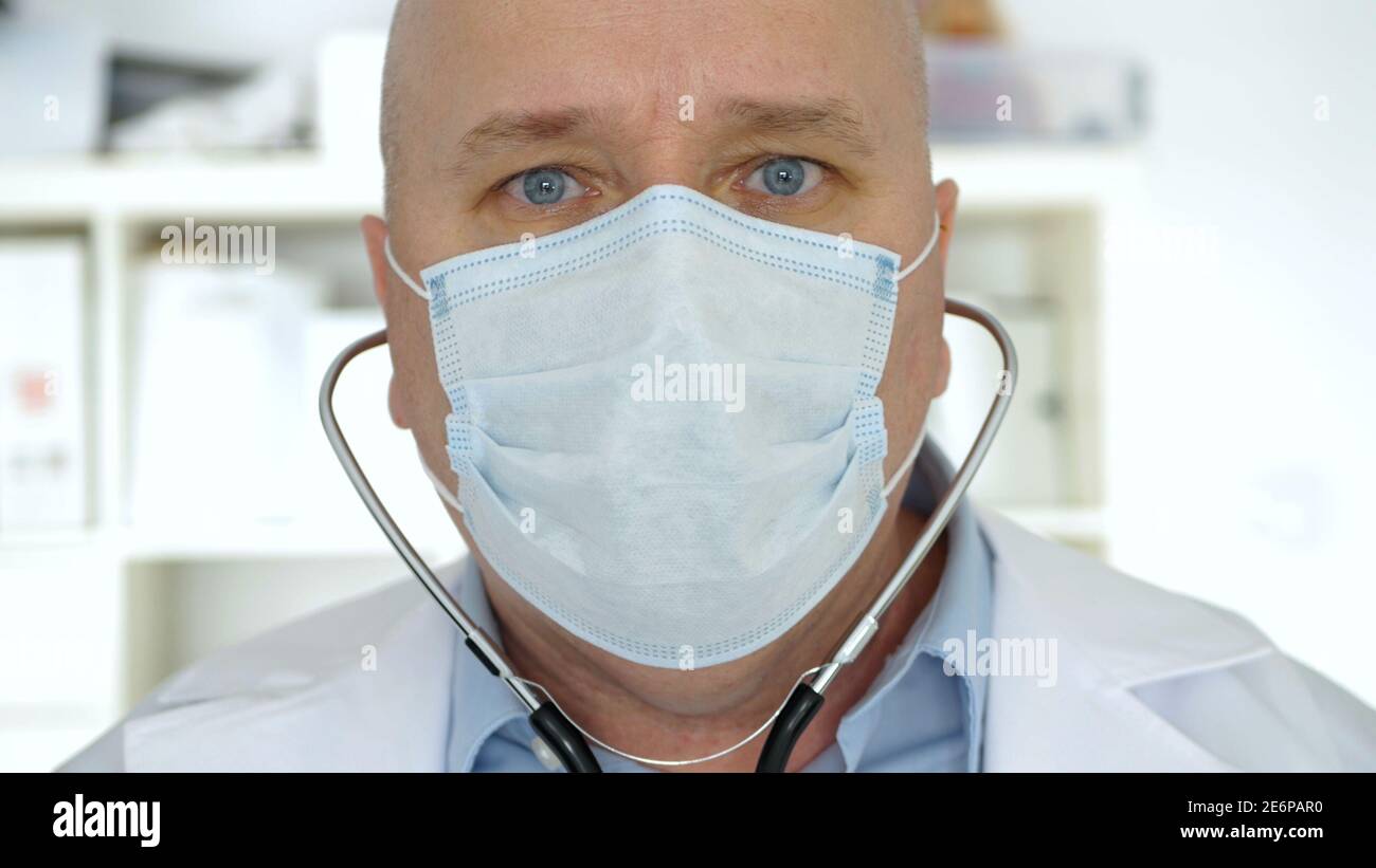 Doctor in a Hospital Wearing Protective Face Mask and Surgical Gloves ...