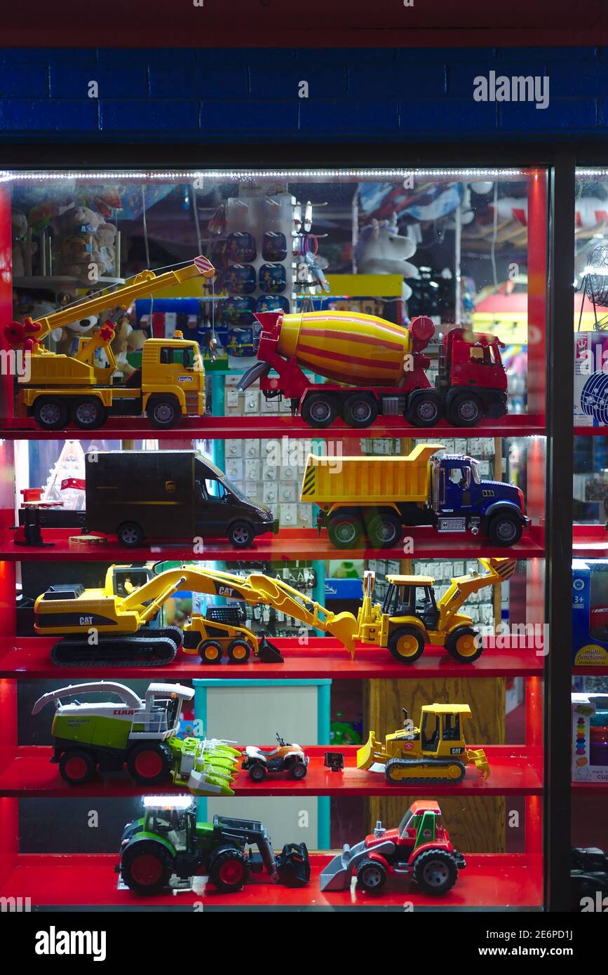 Miniature construction vehicle models on display in a toy store window ...