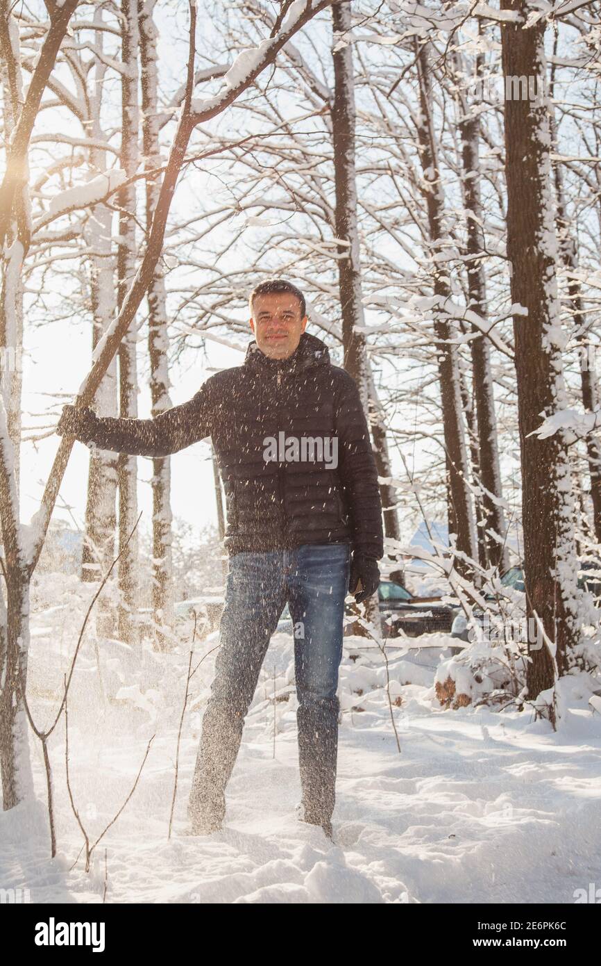 Man shakes tree snowfall hi-res stock photography and images - Alamy